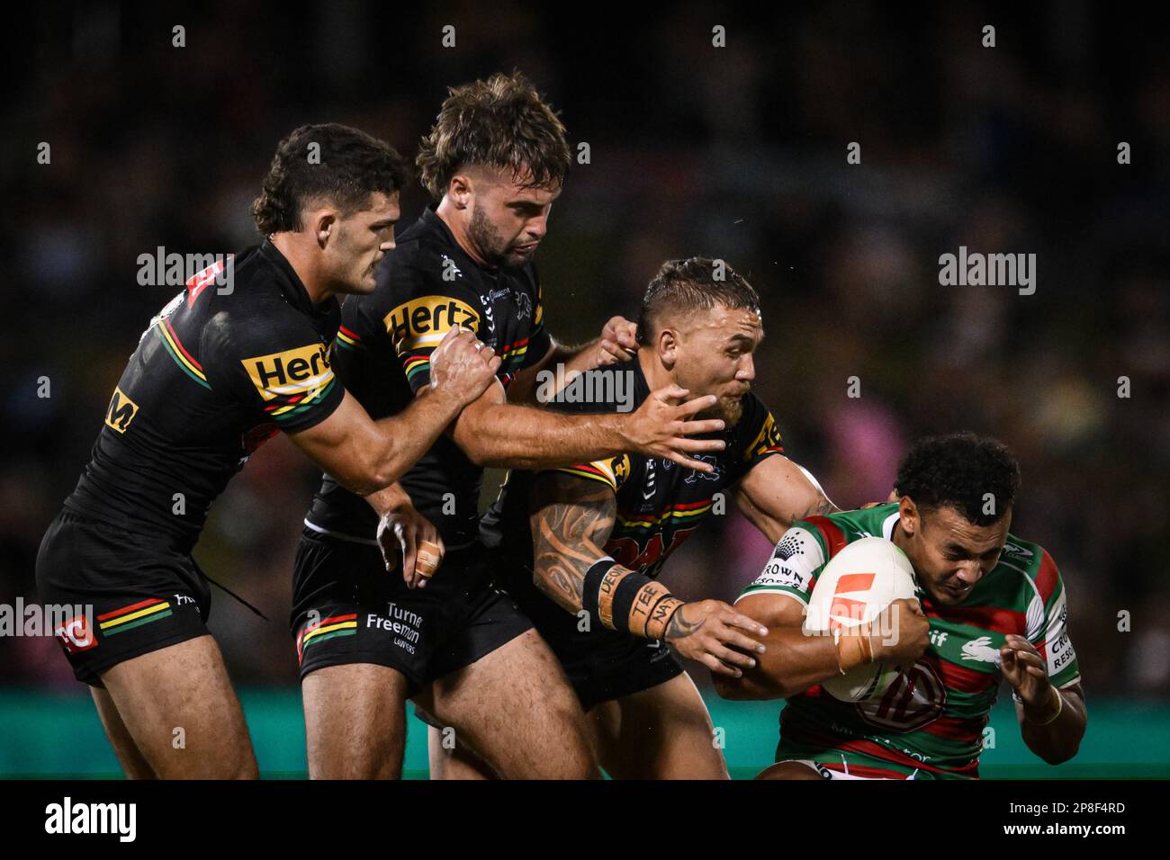 Isaiah Tass of the Rabbitohs is tackled during the NRL Round 2 match between the Penrith ...