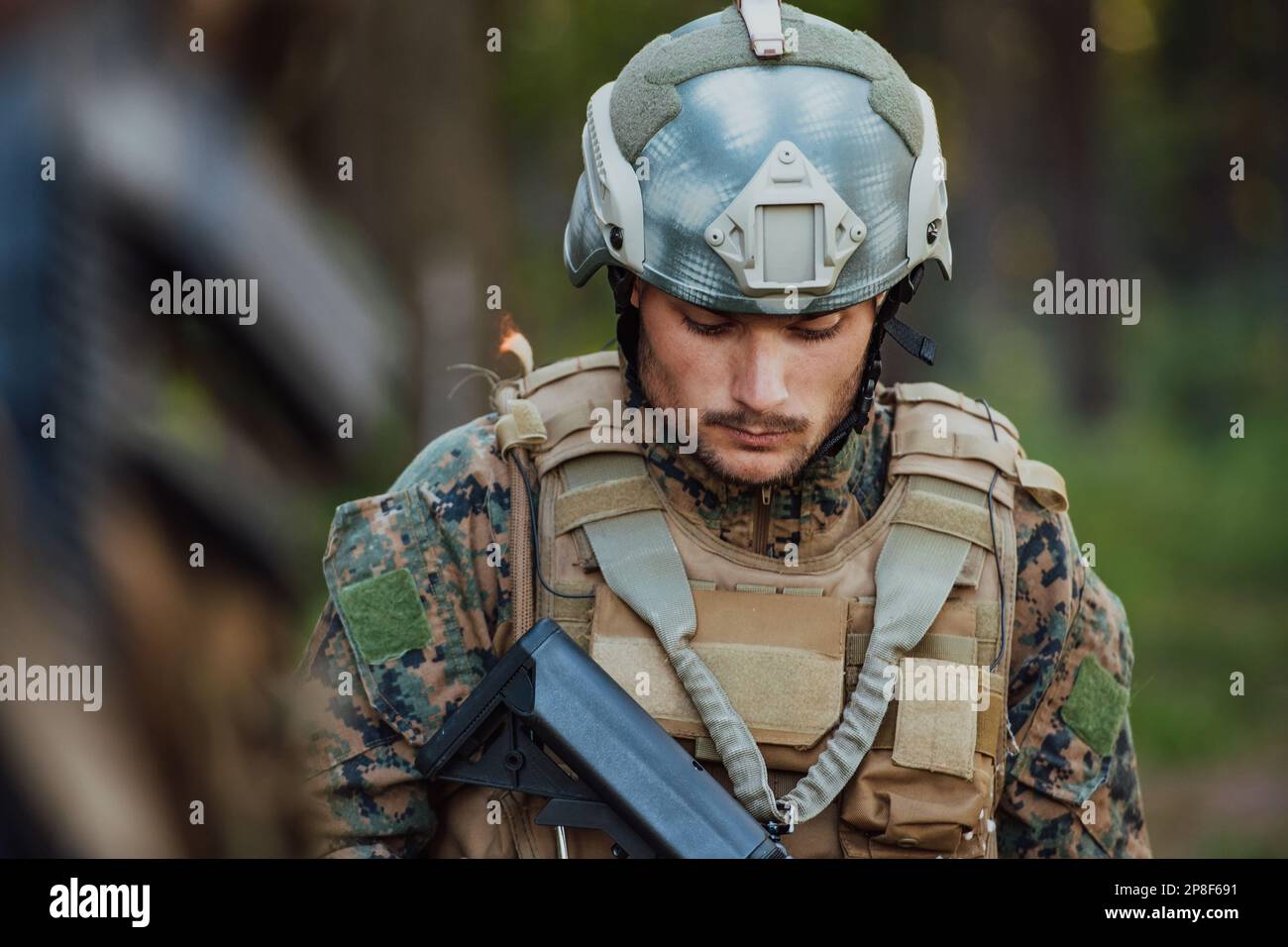 A modern warfare soldier on war duty in dense and dangerous forest ...