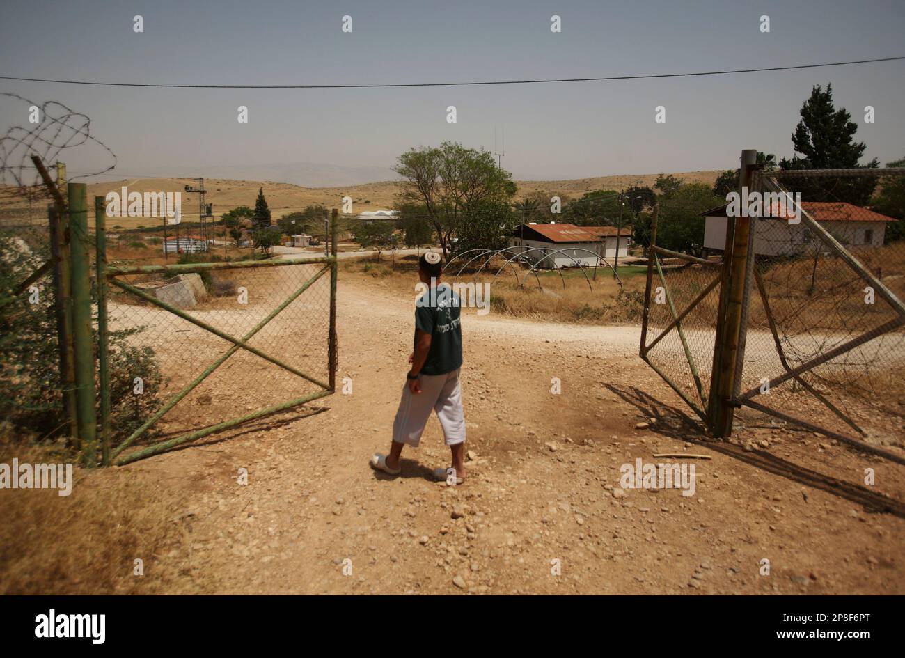An Israeli settler walks in the settlement of Maskiot, in the Jordan ...