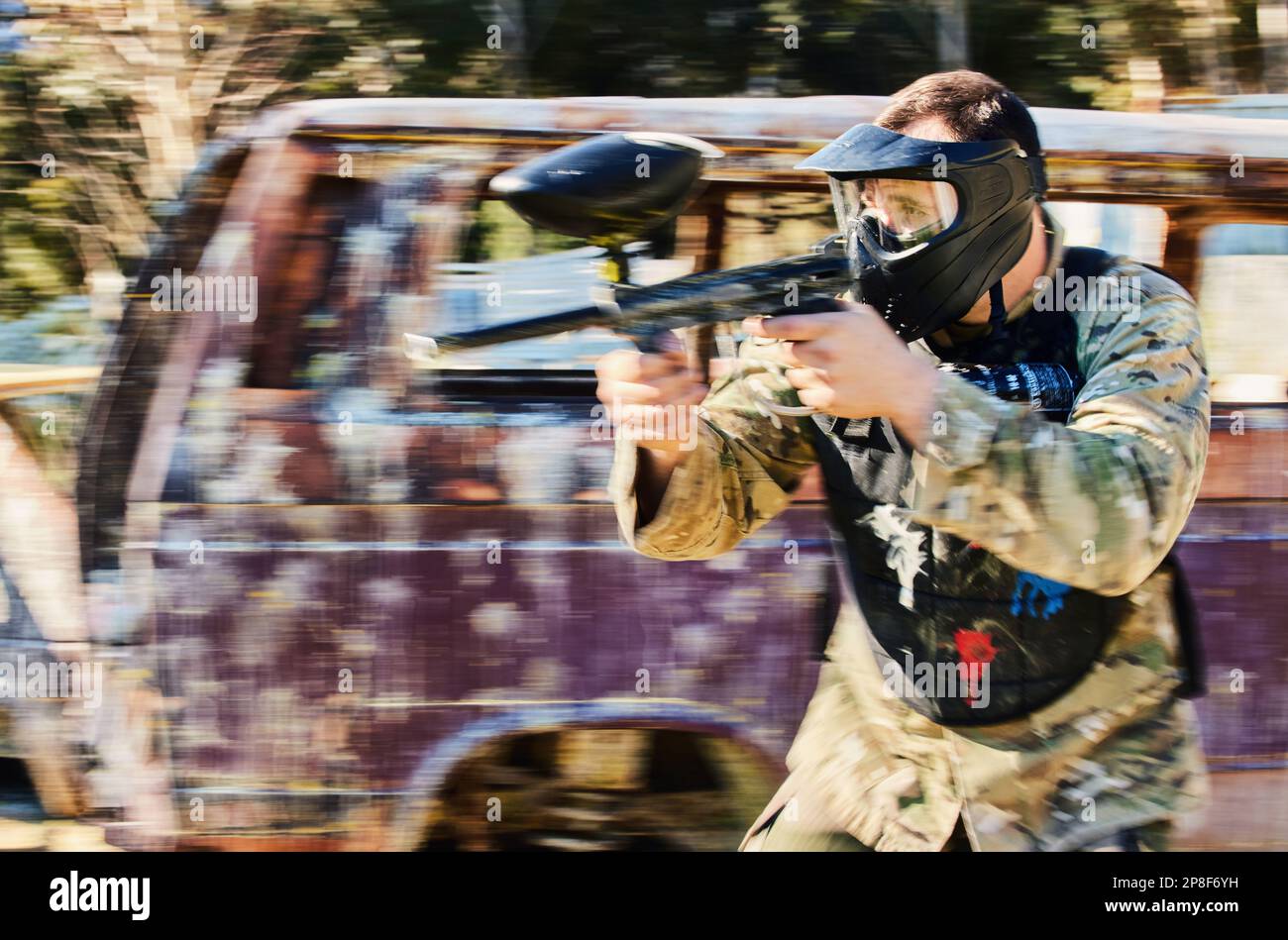 Target, shooting and paintball man with gun for outdoor battlefield, playground or games in ...