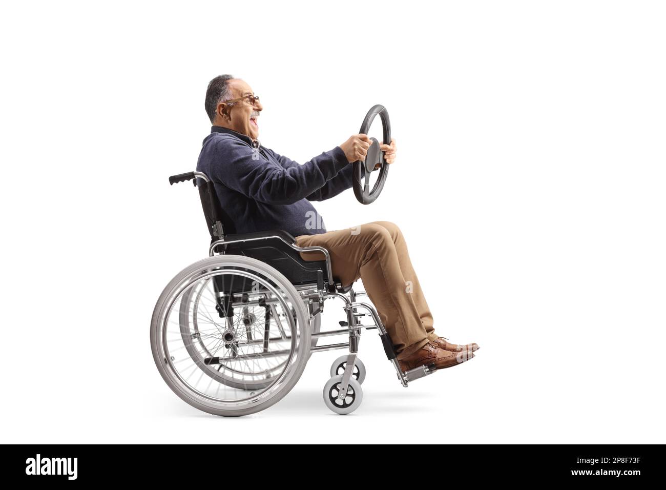 Full length profile shot of a man in a wheelchair holding a steering ...