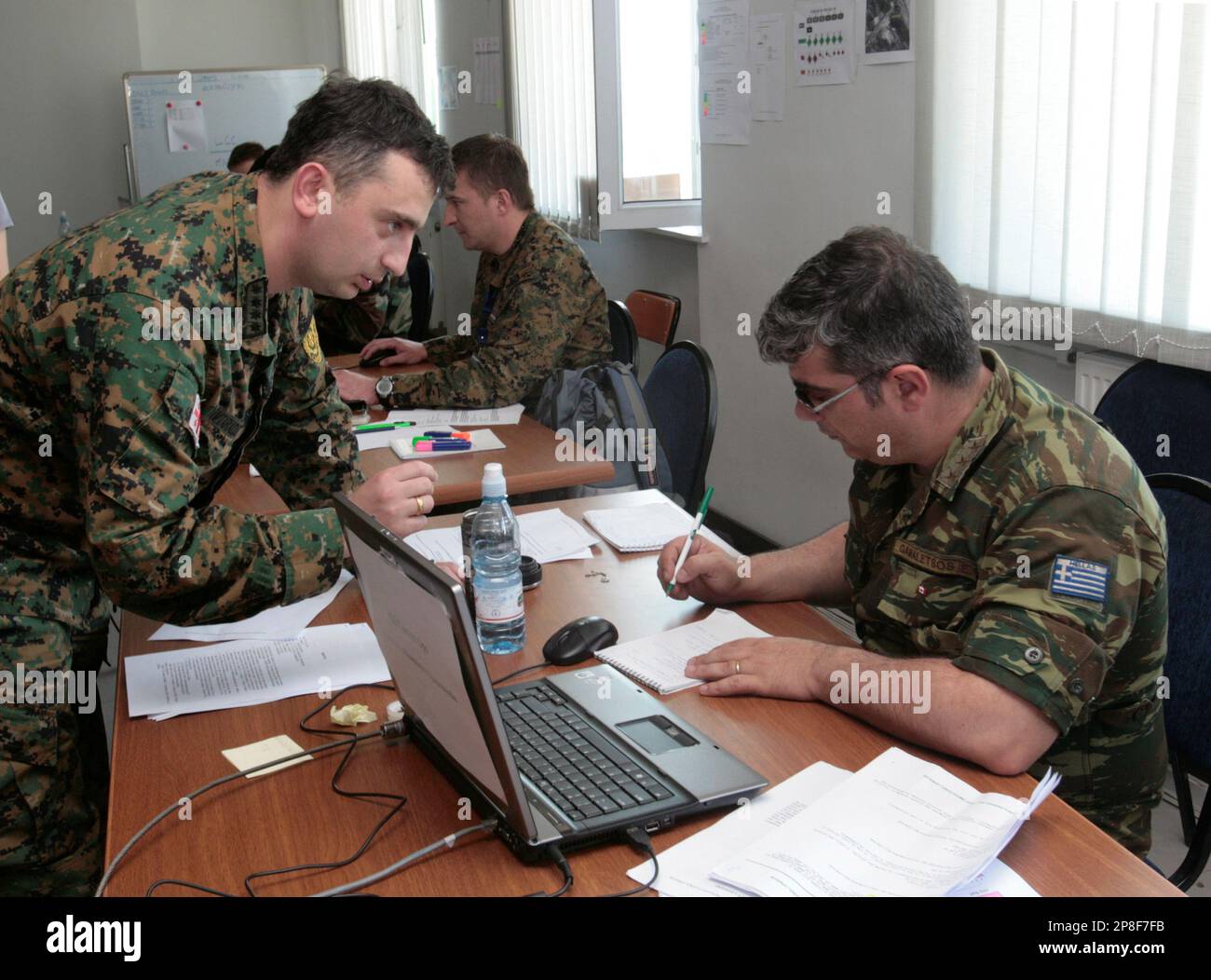 Georgian, left, and Greek, right, military officials speak during joint ...