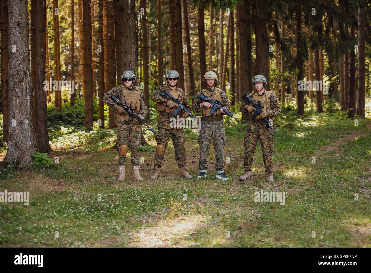 Soldier fighters standing together with guns. Group portrait of US army ...
