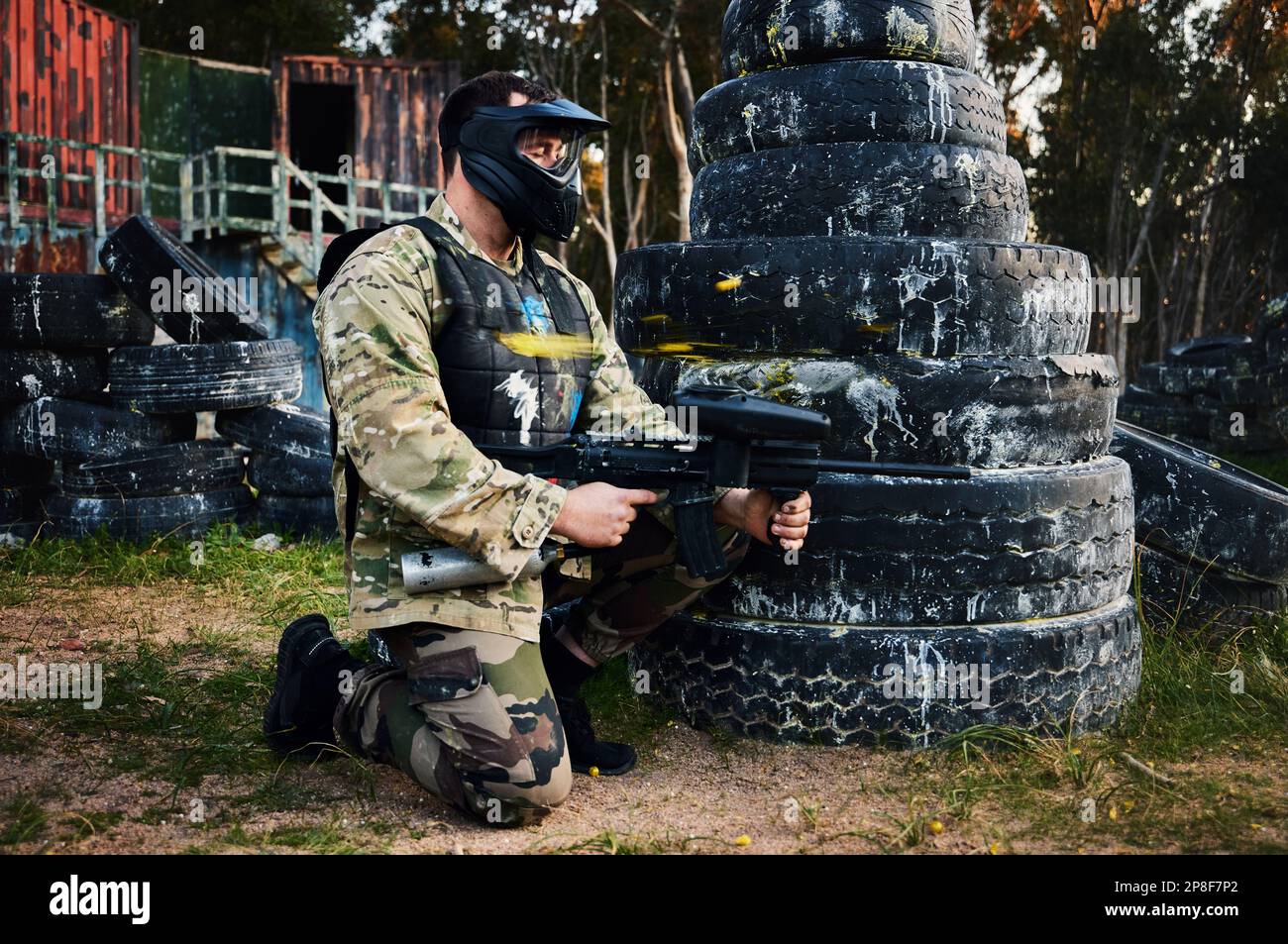 Paintball, gun and camouflage with a sports man on a battlefield for ...