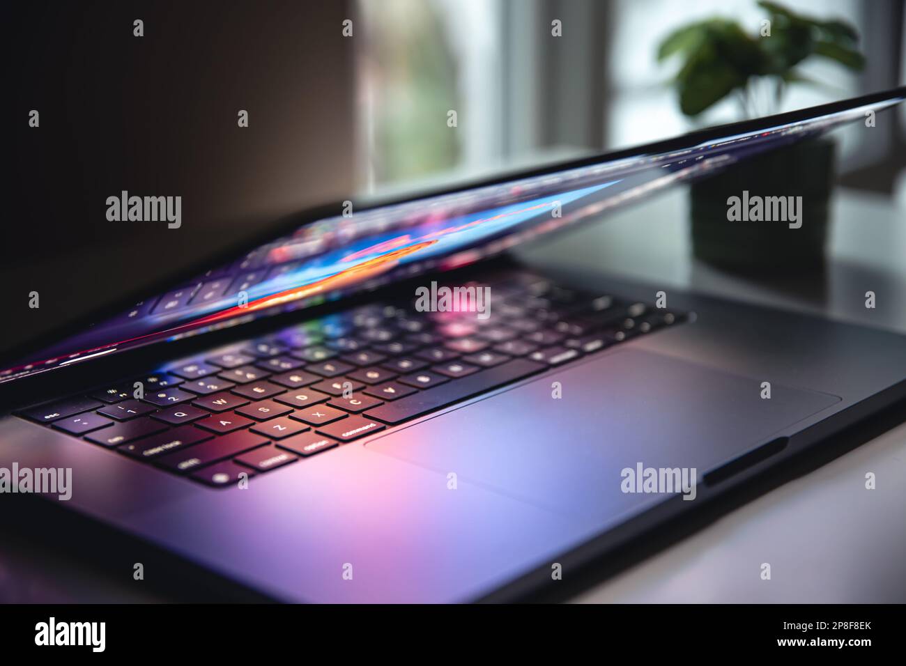 Close up of laptop keyboard colorful neon illumination, backlit ...
