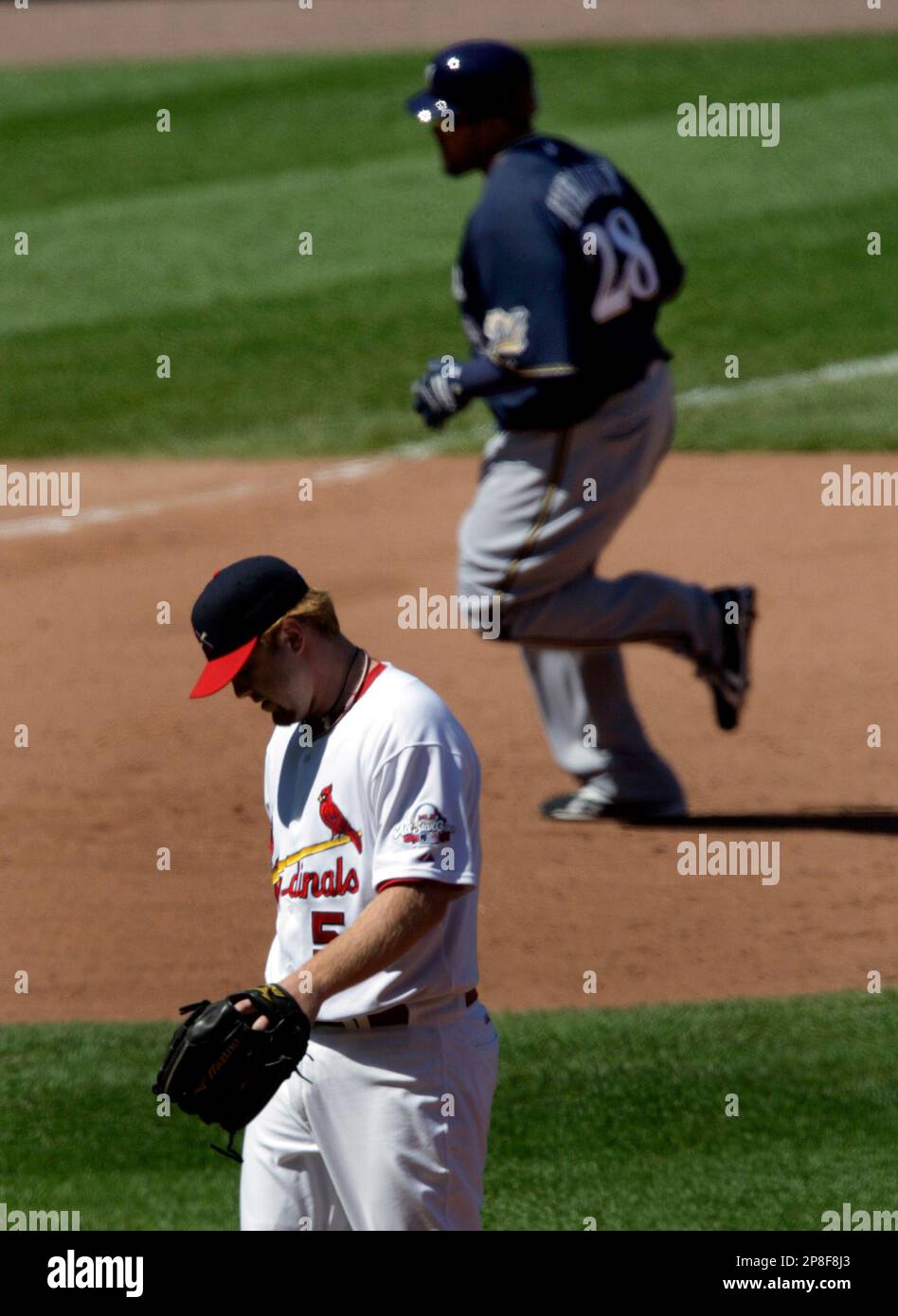 St. Louis Cardinals relief pitcher Blaine Boyer, foreground, walks off ...