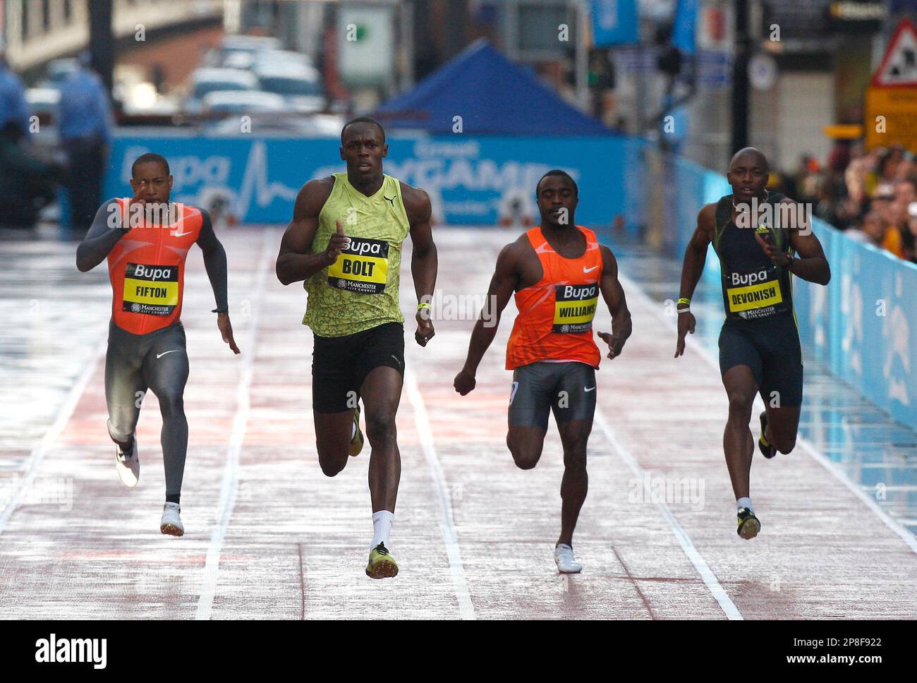 Jamaican athlete Usain Bolt, centre, left in yellow, takes part in the ...