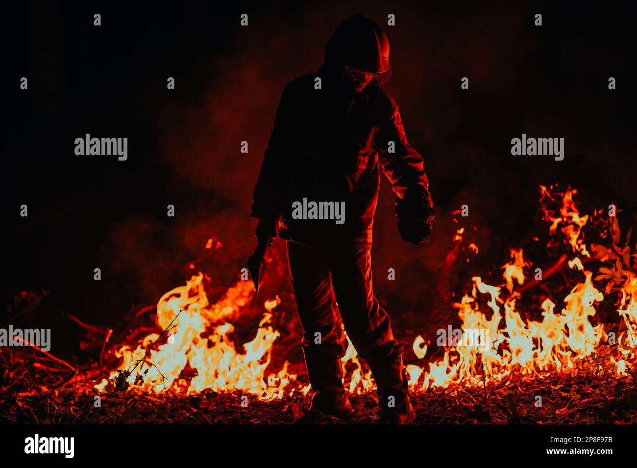 Firefighter at job. Firefighter in dangerous forest areas surrounded by ...