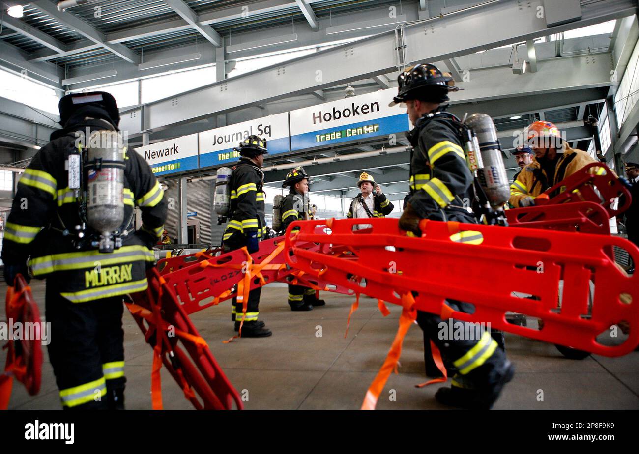Firefighters and paramedics work at the scene of a simulated train ...