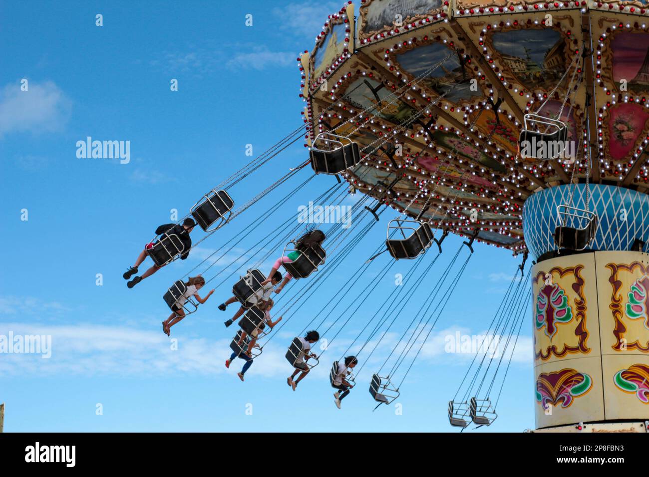 People enjoying the amusement park on a bright sunny summer day in Bray ...