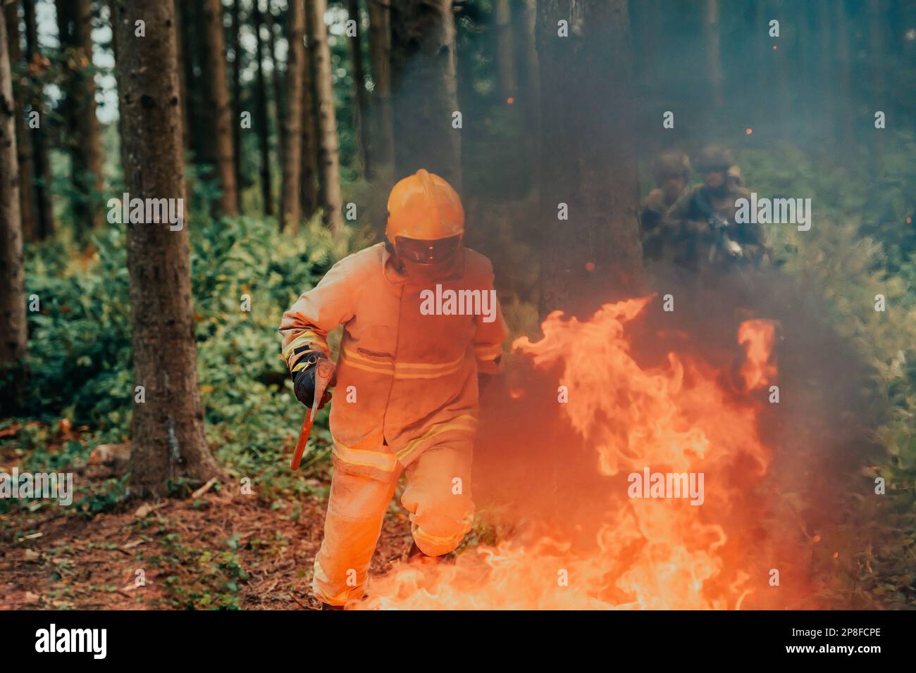 firefighter hero in action danger jumping over fire flame to rescue and ...
