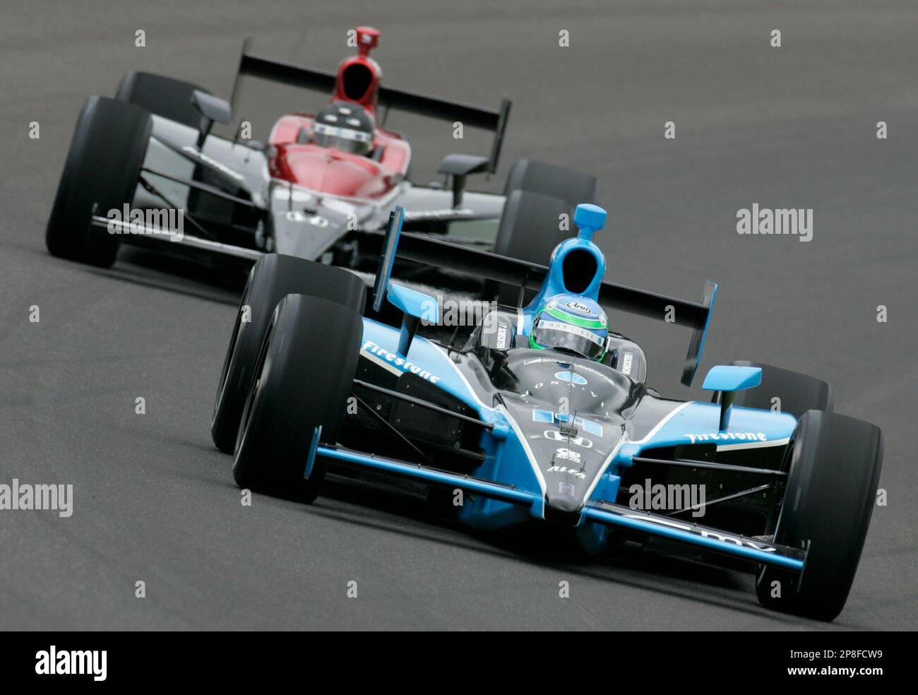 Tomas Scheckter, front, of South Africa, leads Stanton Barrett into the ...