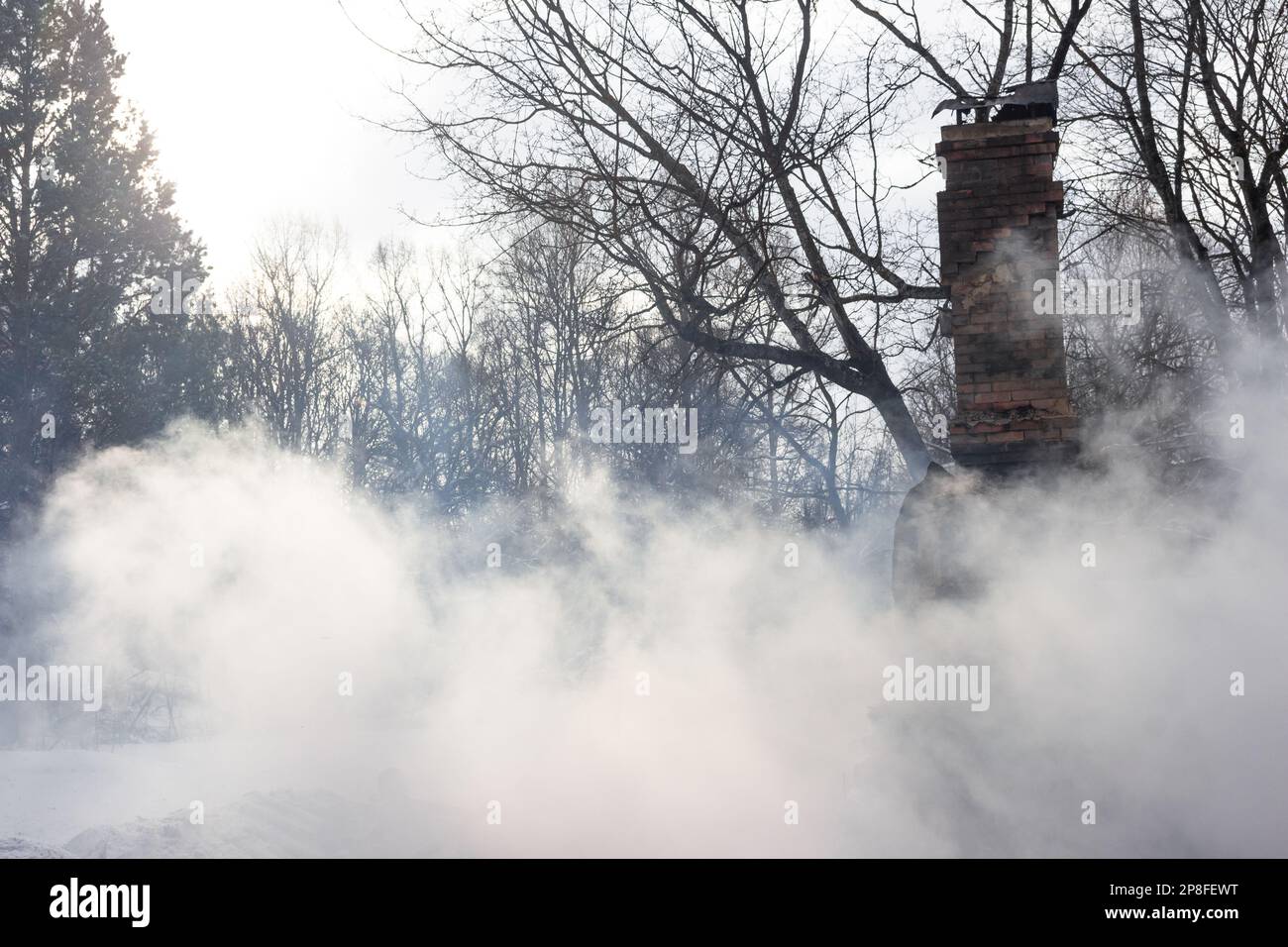 The surviving chimney surrounded by dense smoke after a house fire ...