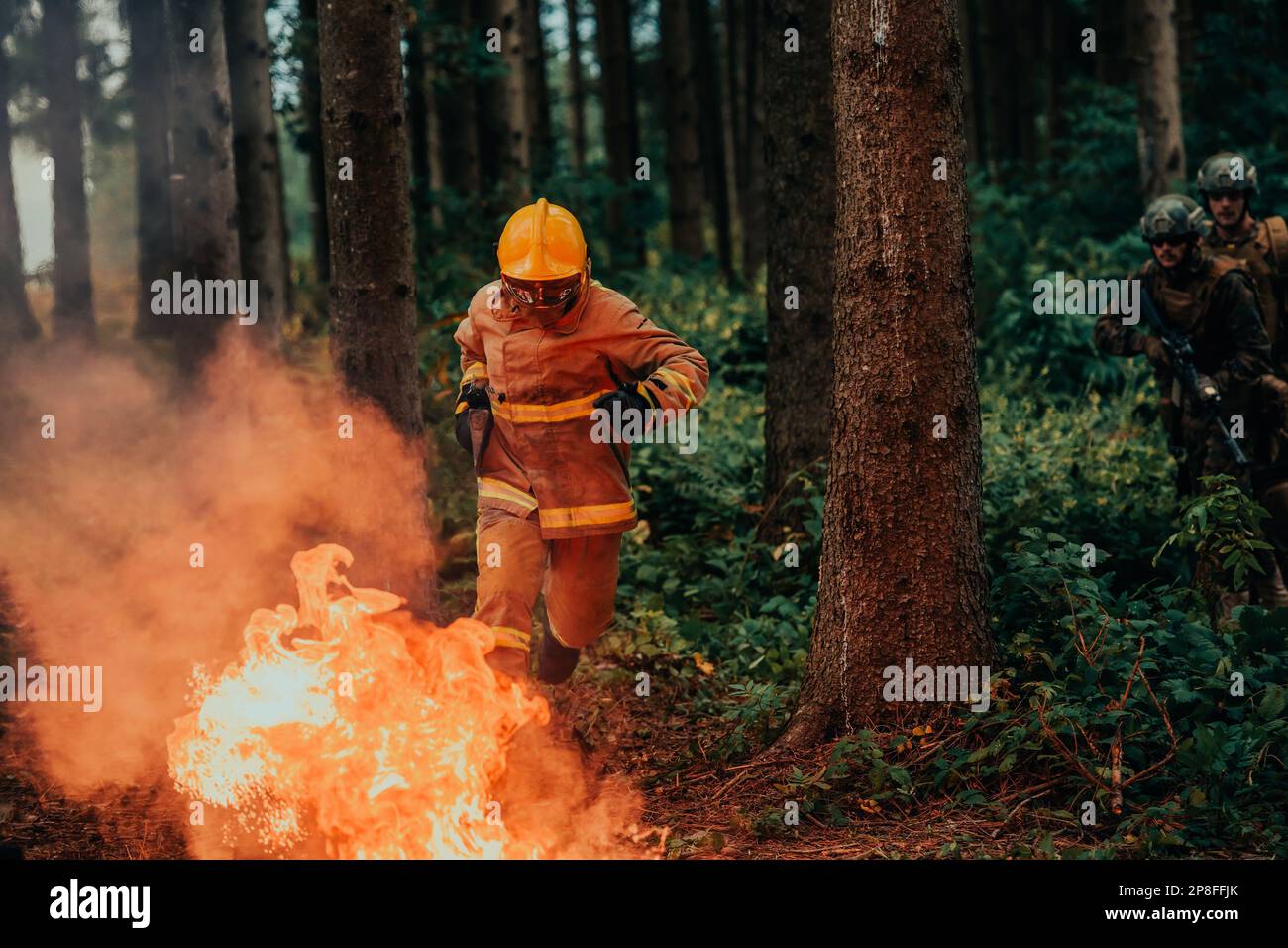 firefighter hero in action danger jumping over fire flame to rescue and ...