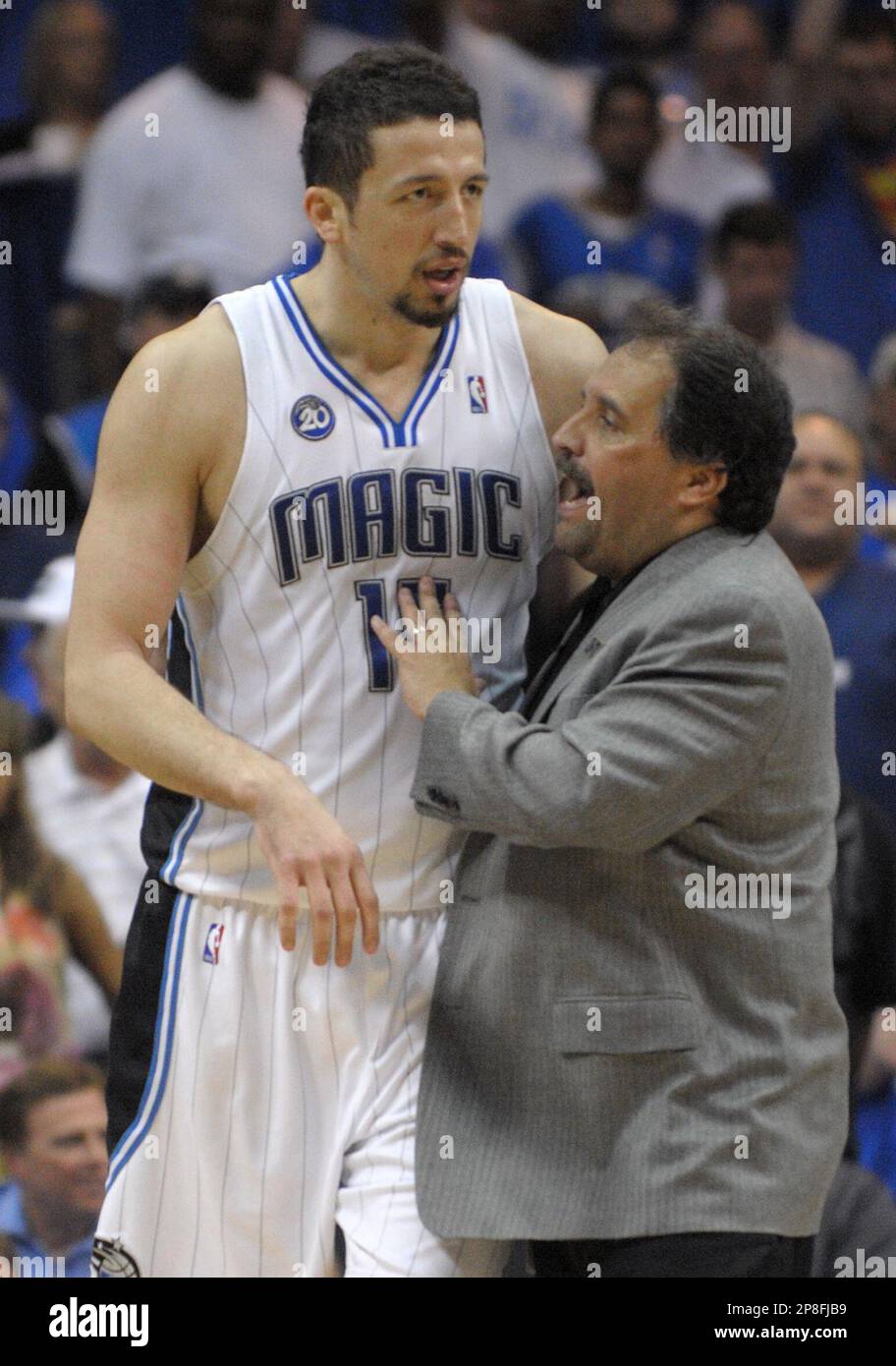 Orlando Magic forward Hedo Turkoglu, left, of Turkey, is restrained by ...