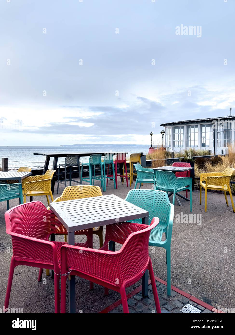 Multi-colored chairs on the terrace of a cafe by the sea Stock Photo ...