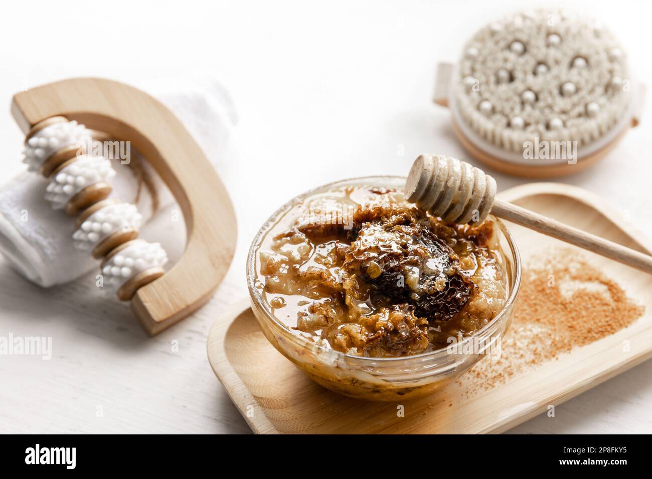 Spa composition with honey and dipper close up Stock Photo - Alamy