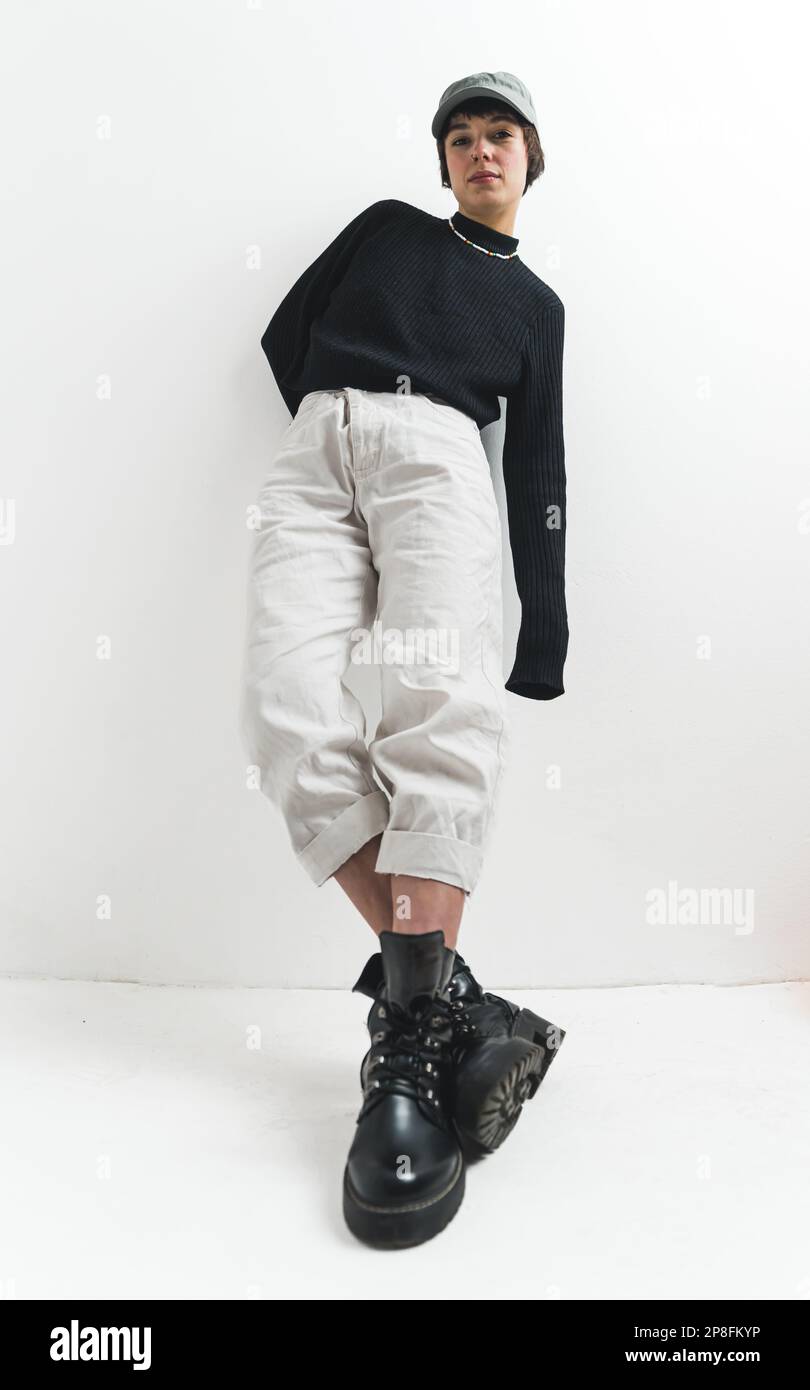 Vertical low angle shot. Female model posing leaning her back against a ...