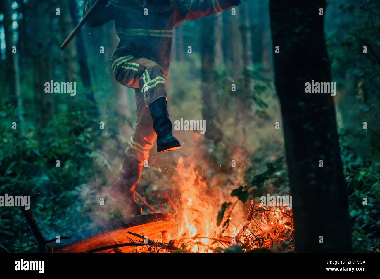 firefighter hero in action danger jumping over fire flame to rescue and ...