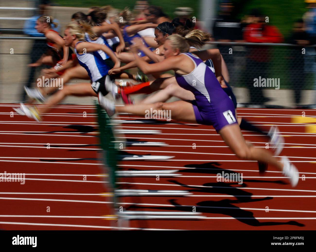 Girls compete in the 100m hurdles prelim at the Class 4A high school ...