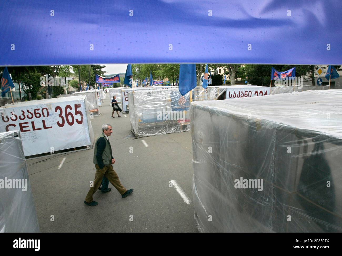 In this photo taken Tuesday, May 12, 2009, Georgians walk among mock ...