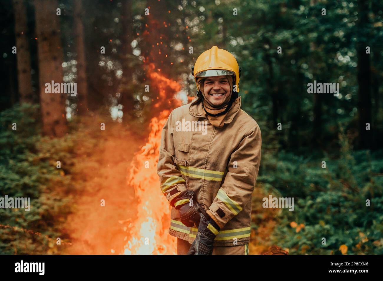 Firefighter at job. Firefighter in dangerous forest areas surrounded by ...
