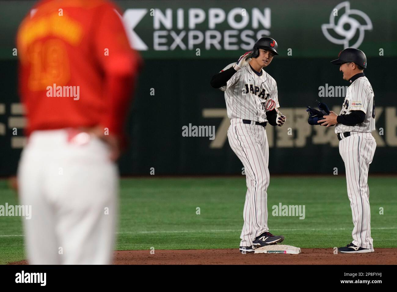 Shohei Ohtani of Japan gestures on the second base after hitting a double in the fourth inning ...