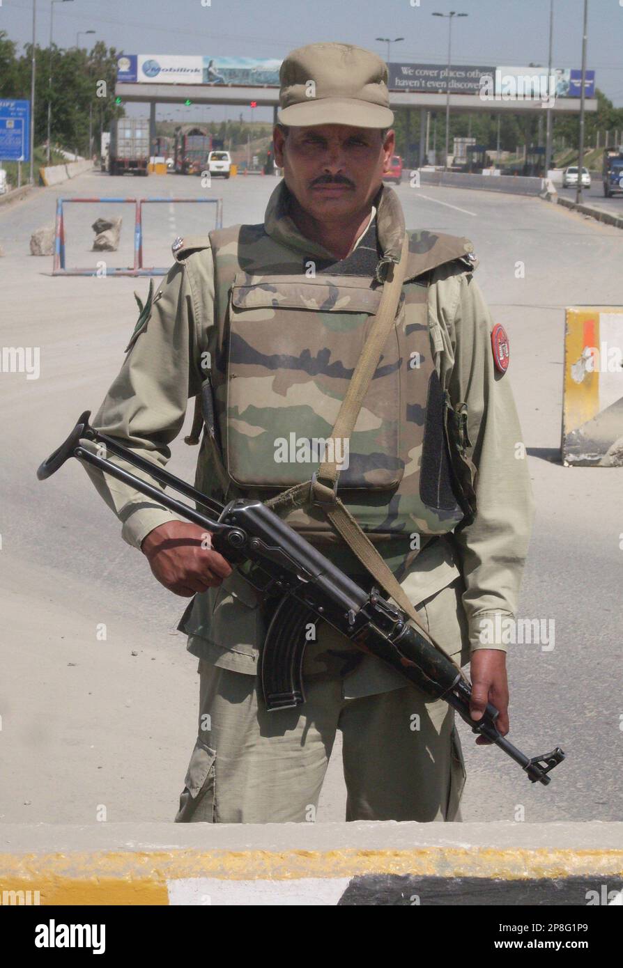 A soldier of Pakistani paramilitary force stands guard at an entry post ...