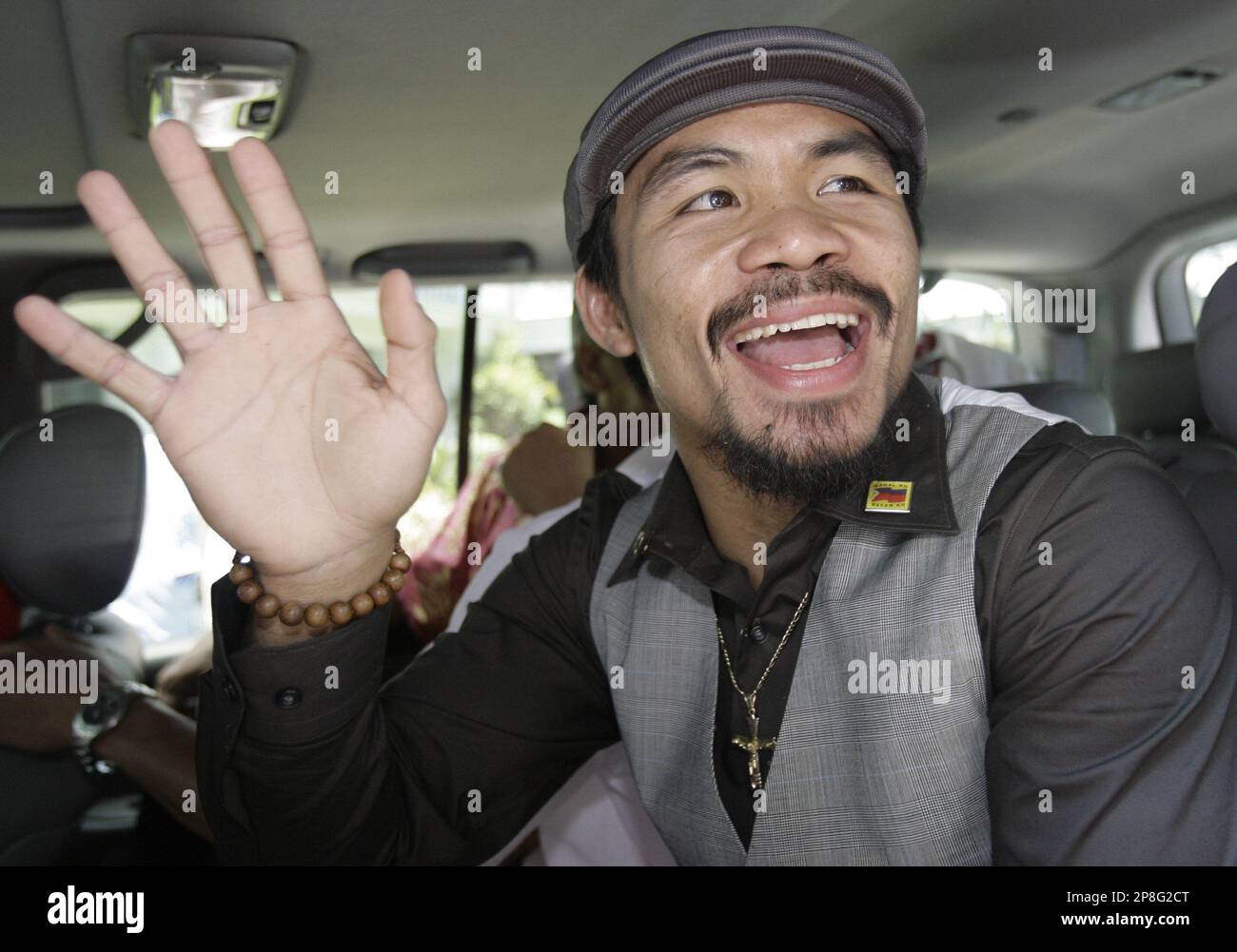 Filipino boxing star Manny Pacquiao waves to the crowd as he leaves ...