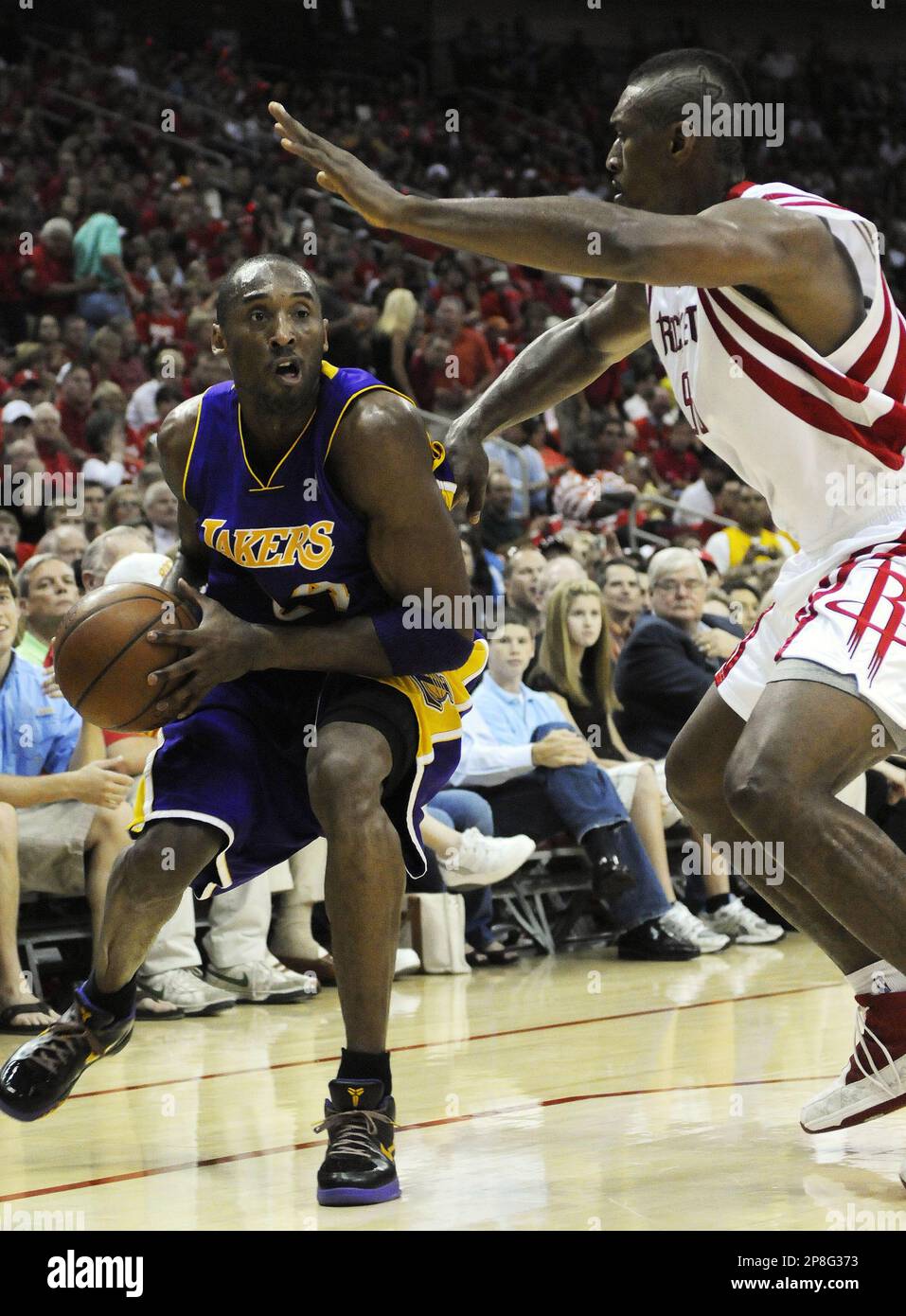 Los Angeles Lakers' Kobe Bryant, left, looks to shoot as Houston ...