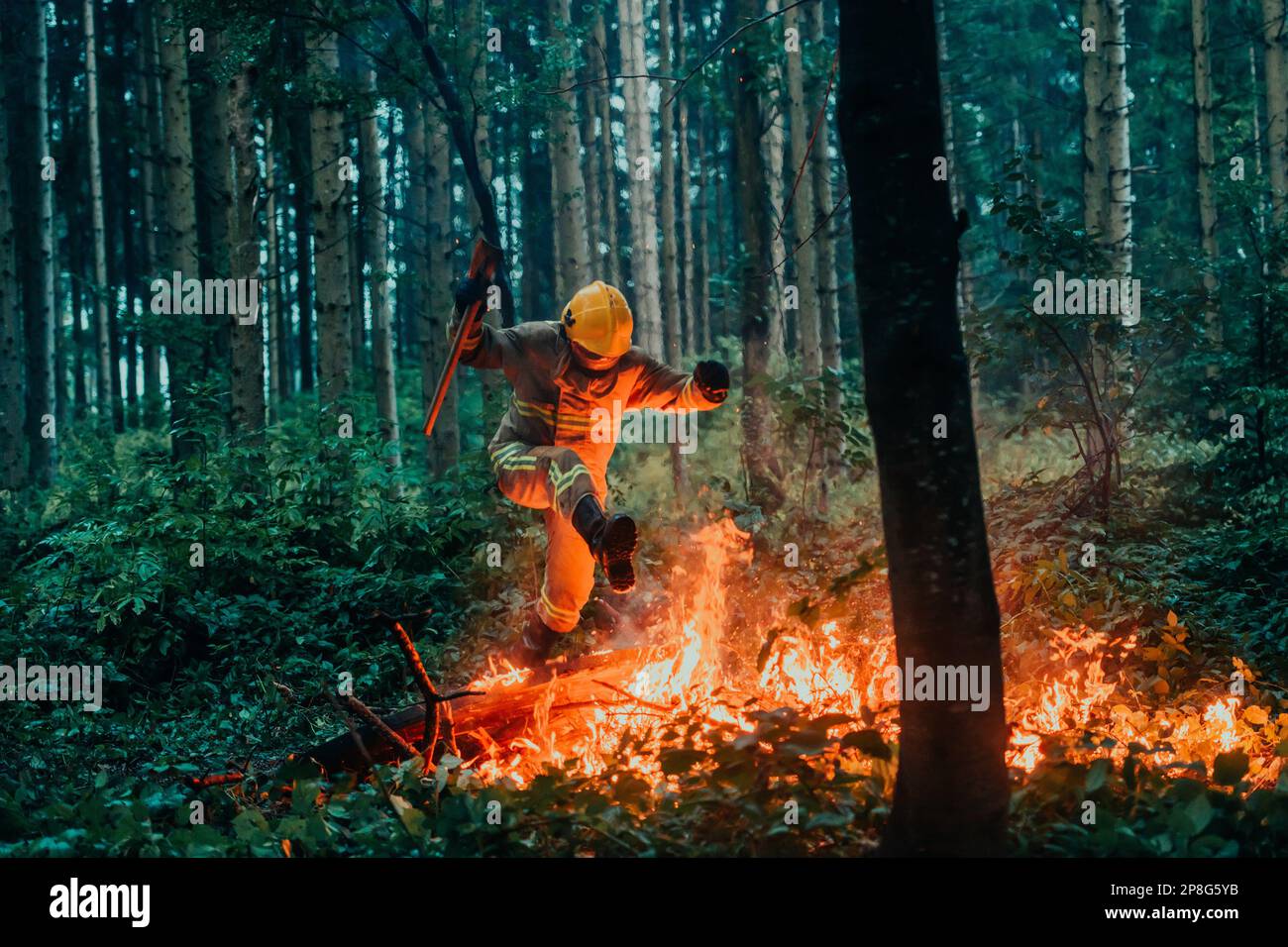 firefighter hero in action danger jumping over fire flame to rescue and ...