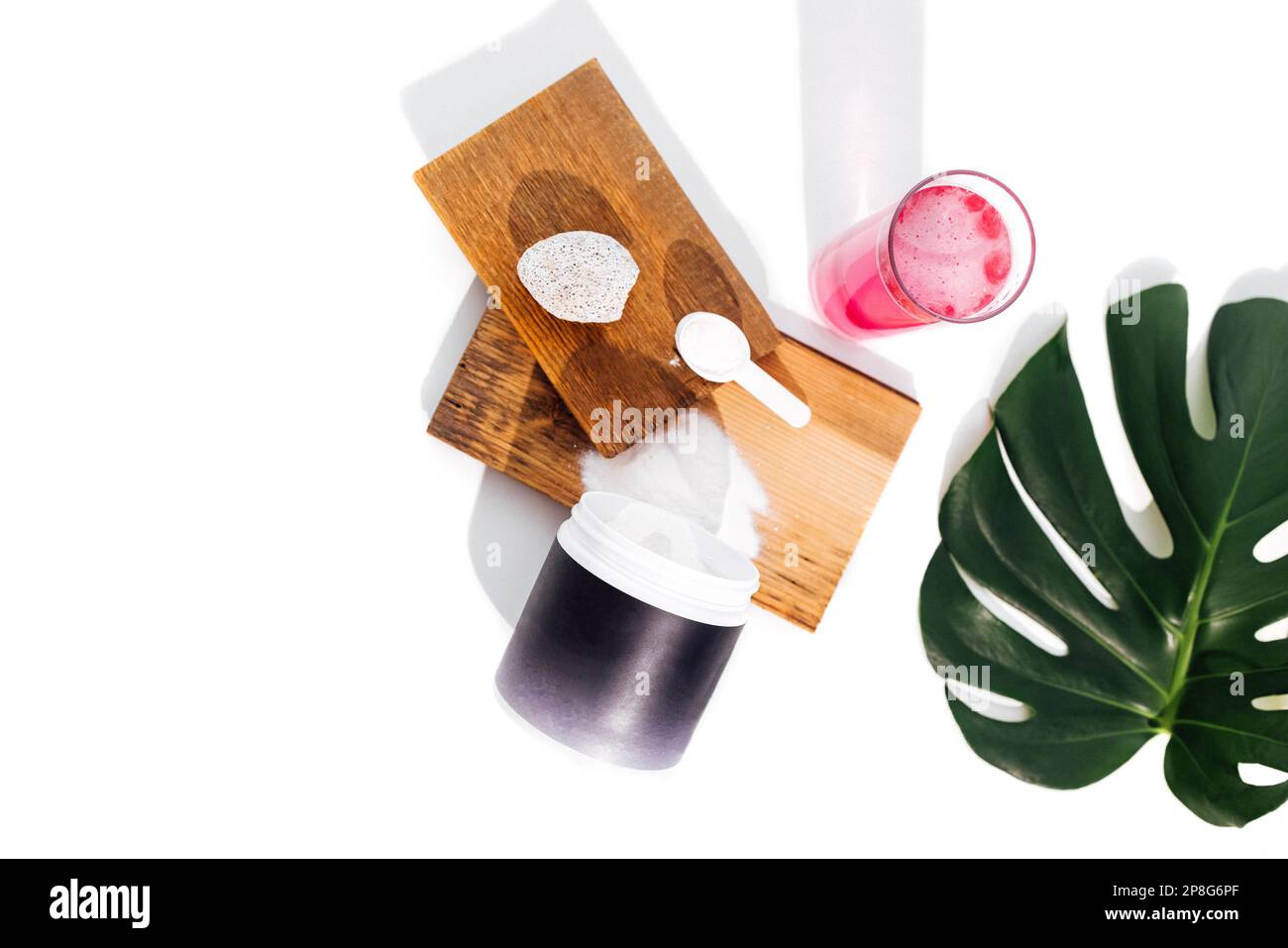 Mockup of plastic jar for collagen powder. Spoon with collagen on ...