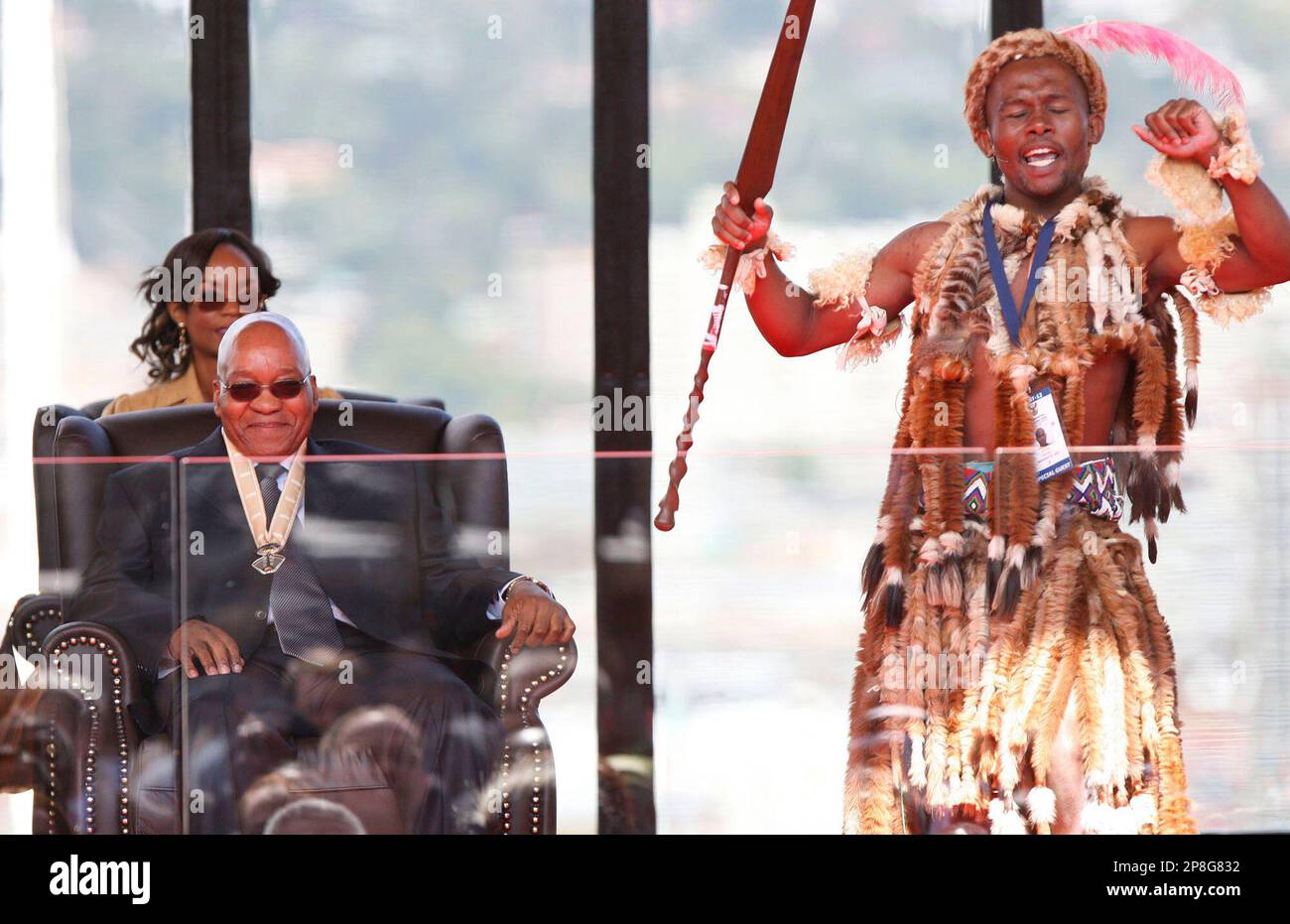 South African President Jacob Zuma, left, watches as a Zulu singer ...