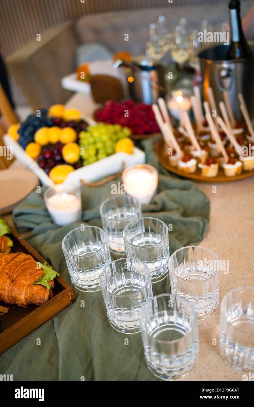 Swiss table at the party. Close up of croissants with greens and ...
