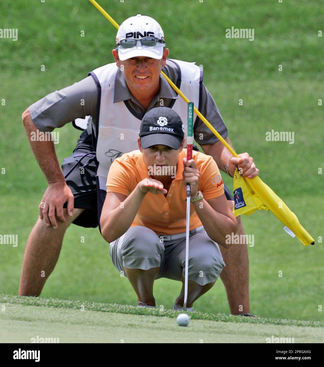 Lorena Ochoa, from Mexico and her caddie Adam Woodward look over a putt ...