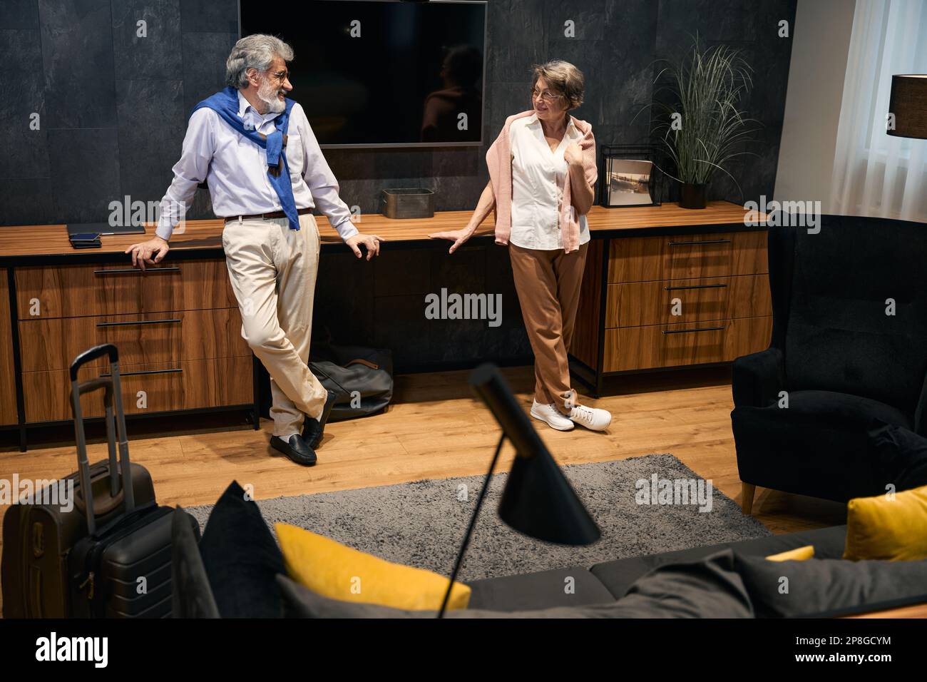 Modern traveling elderly couple drove into a comfortable hotel Stock ...