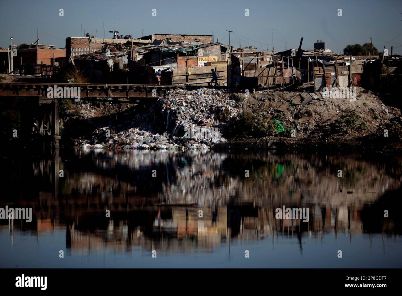 Waste and houses line the borders of the Riachuelo river in Buenos ...
