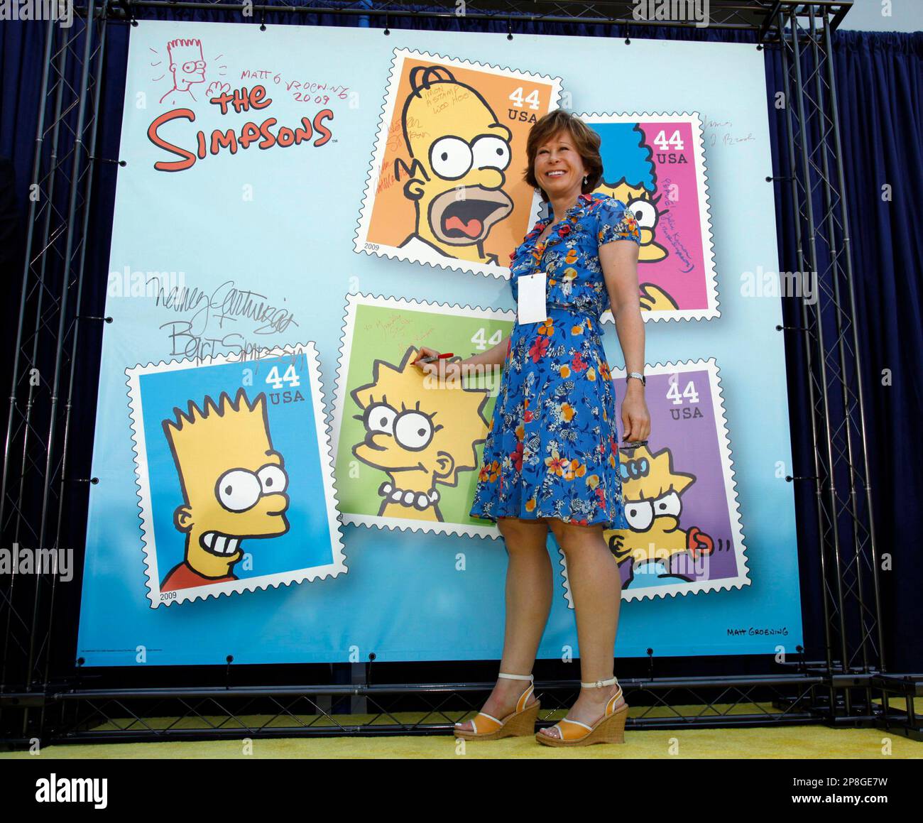 Yeardley Smith, the voice of Lisa Simpson, signs a poster at the ...