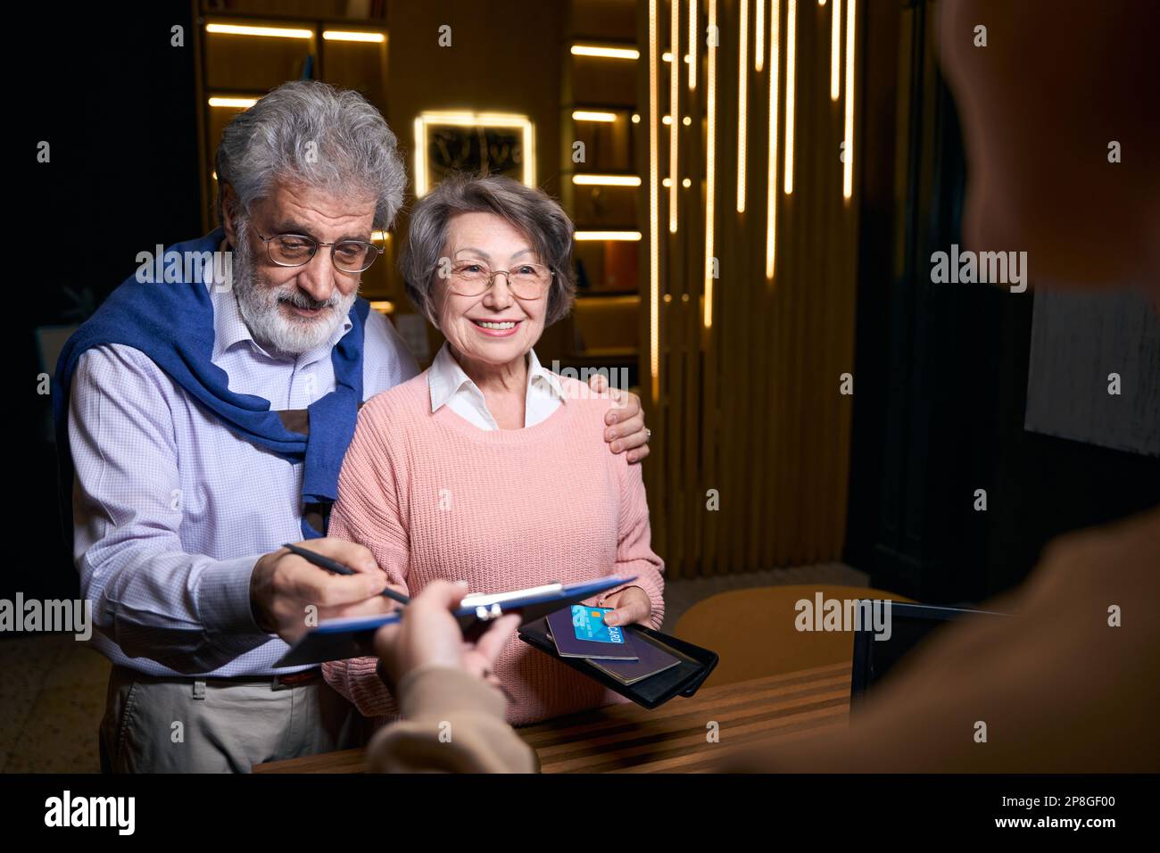 Smiling elderly man is registered in the magazine at reception Stock ...