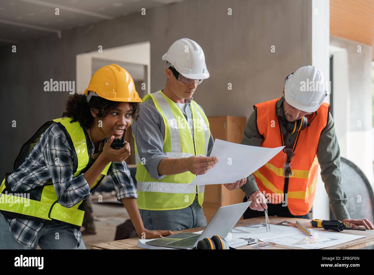 female architect holding walkie talkie and male civil engineer with ...
