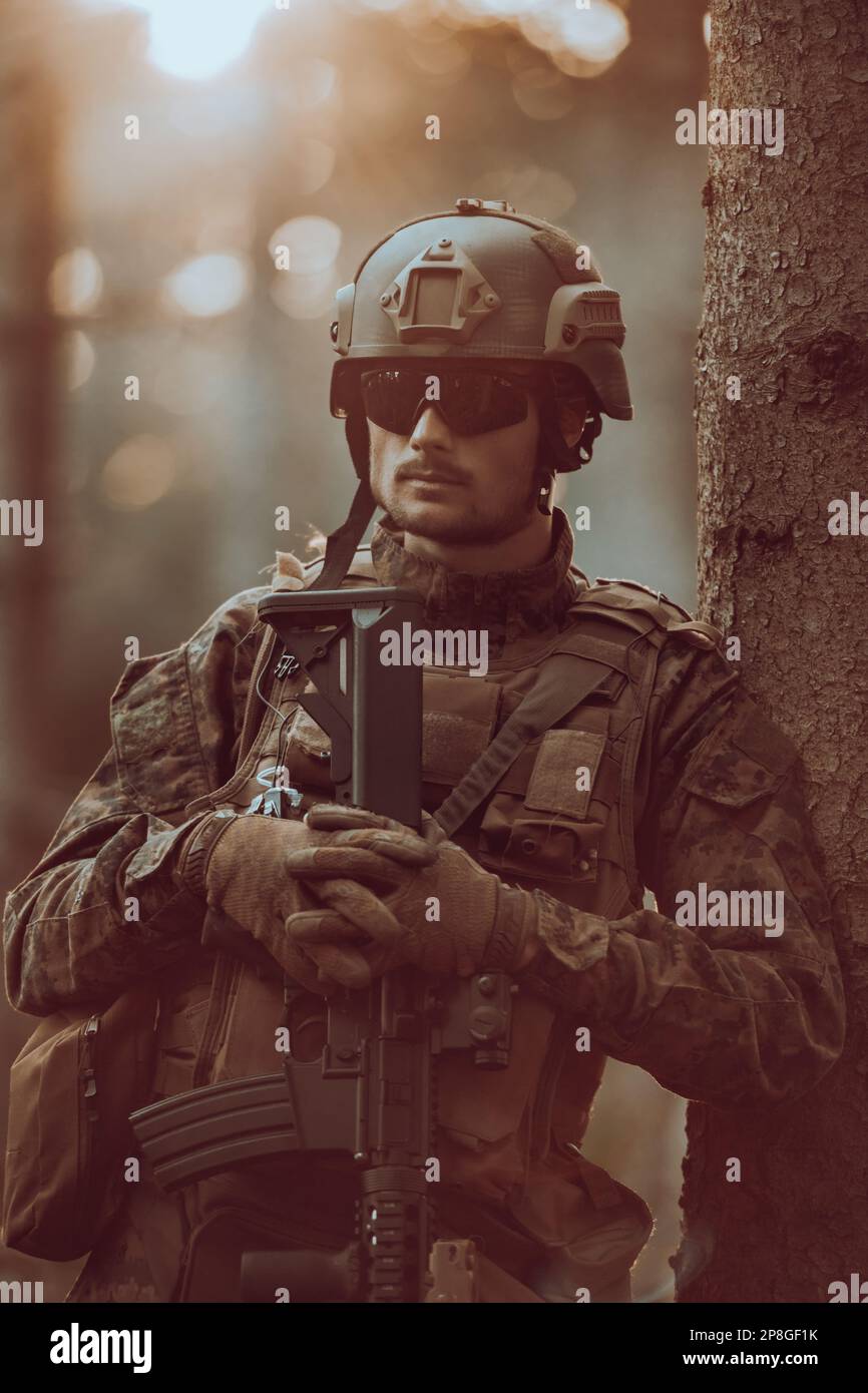 A modern warfare soldier on war duty in dense and dangerous forest ...