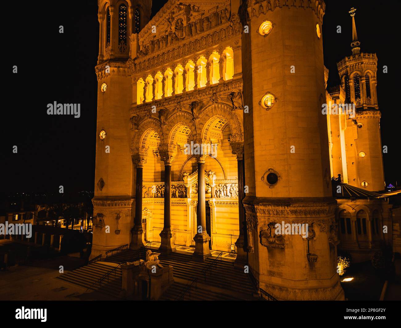 Panoramic aerial shot at night time of illuminated Basilica Notre Dame ...