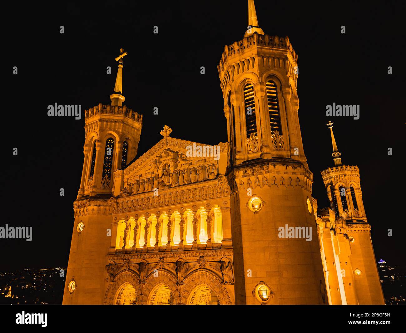 Panoramic aerial shot at night time of illuminated Basilica Notre Dame ...