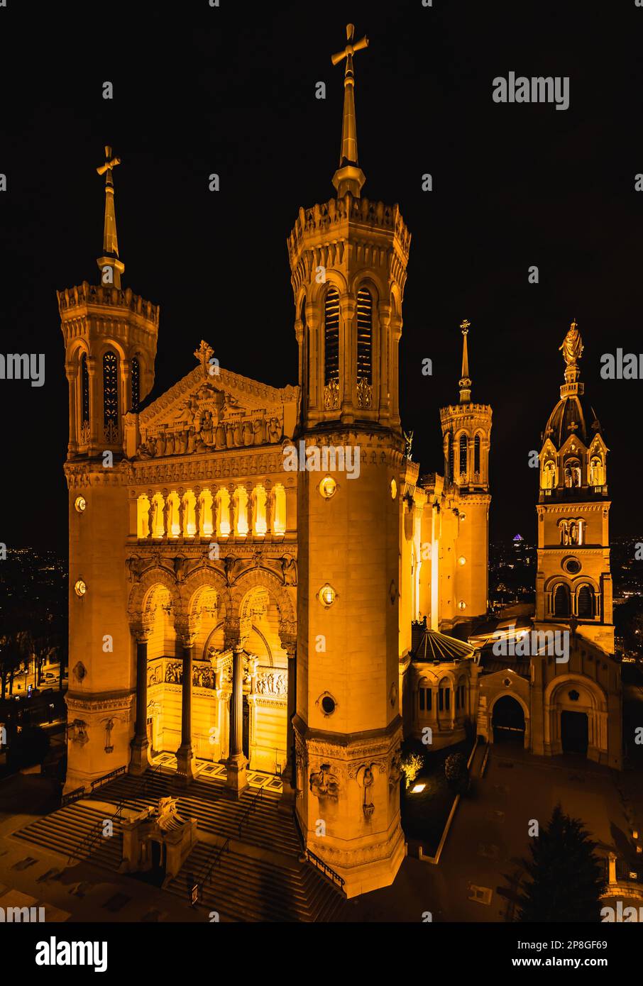 Panoramic aerial shot at night time of illuminated Basilica Notre Dame ...