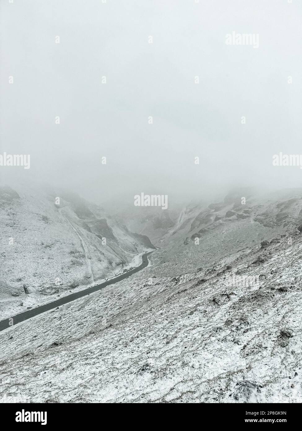 Snowy rocky mountain on Winnat's Pass on a cloudy day in the Peak ...