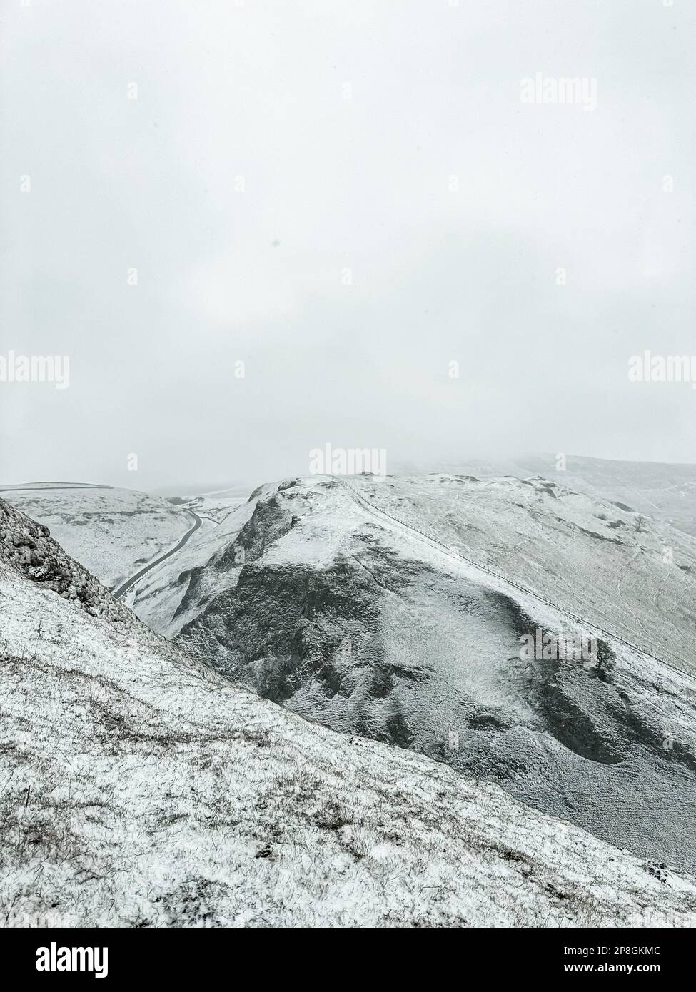 Snowy rocky mountain on Winnat's Pass on a cloudy day in the Peak ...