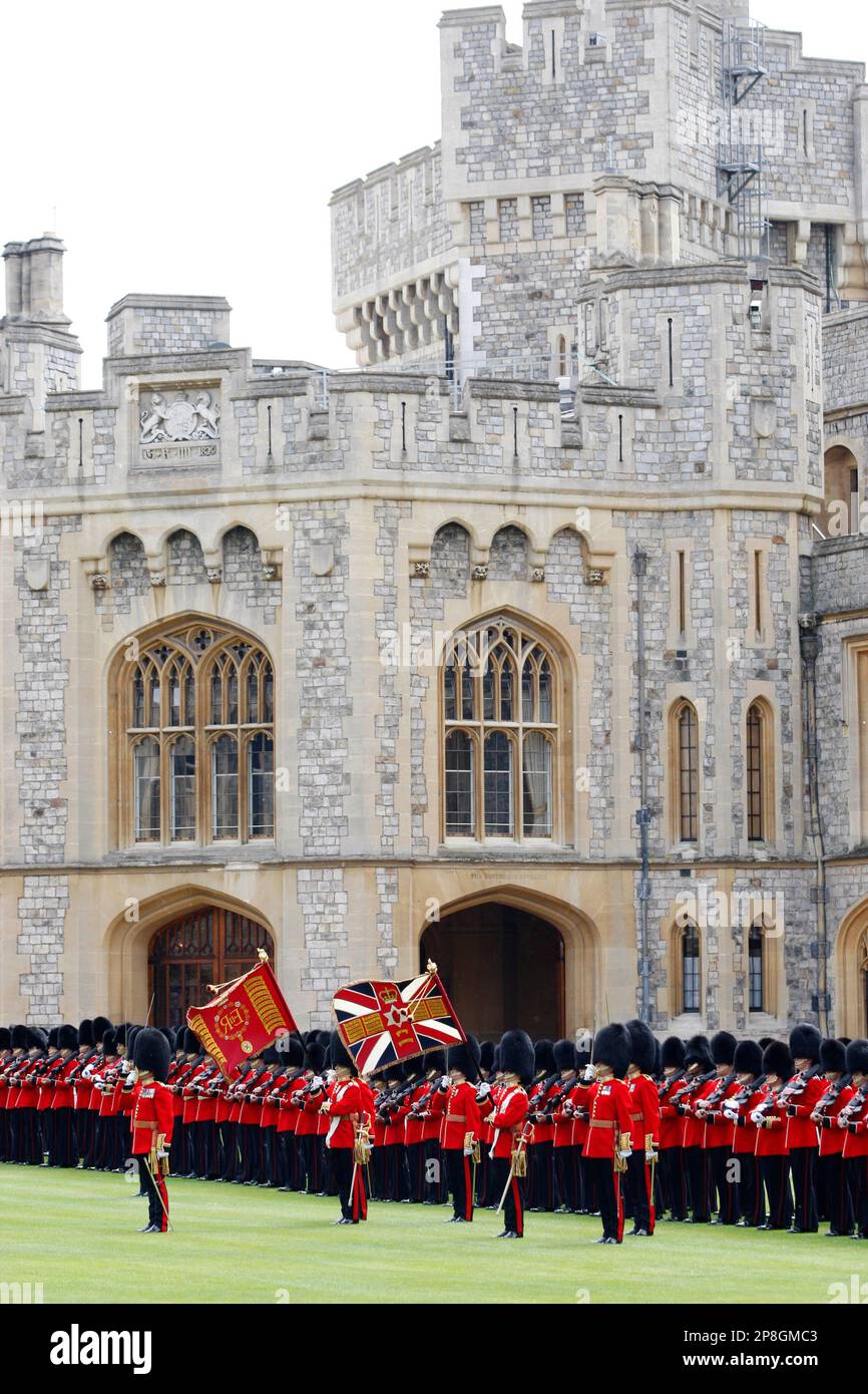 The troops raise the new Queen's Colour, center left, and the new ...