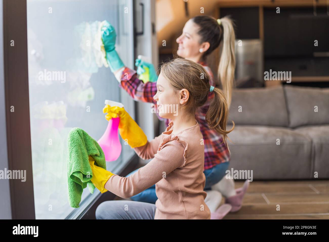 Happy daughter and mother cleaning house together Stock Photo - Alamy