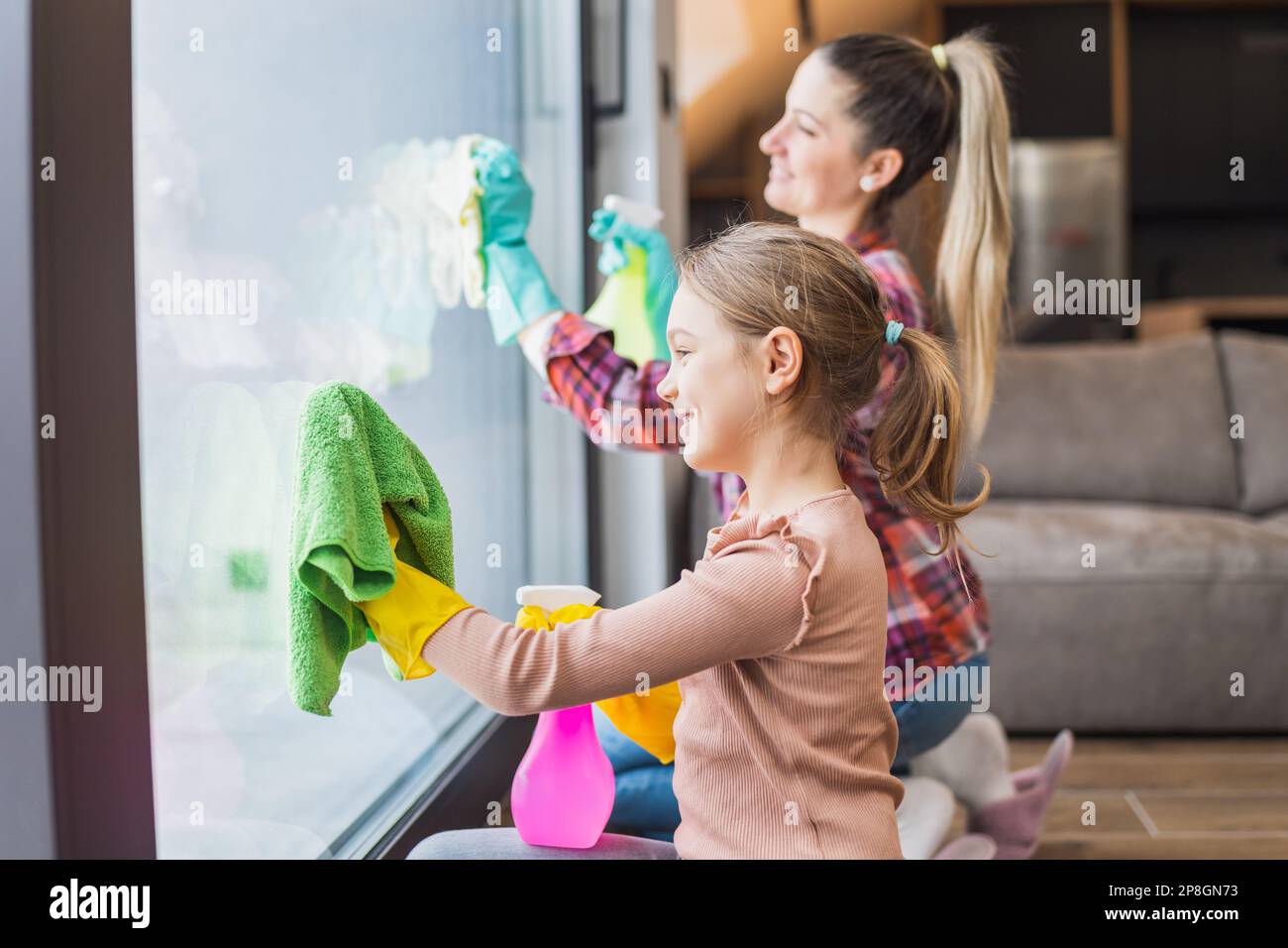 Happy daughter and mother cleaning house together Stock Photo - Alamy