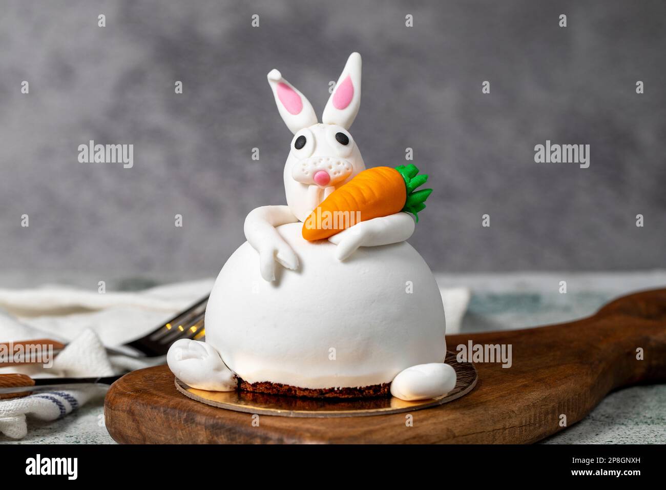 Specially designed bunny shaped cake. Cake on gray wooden table and ...